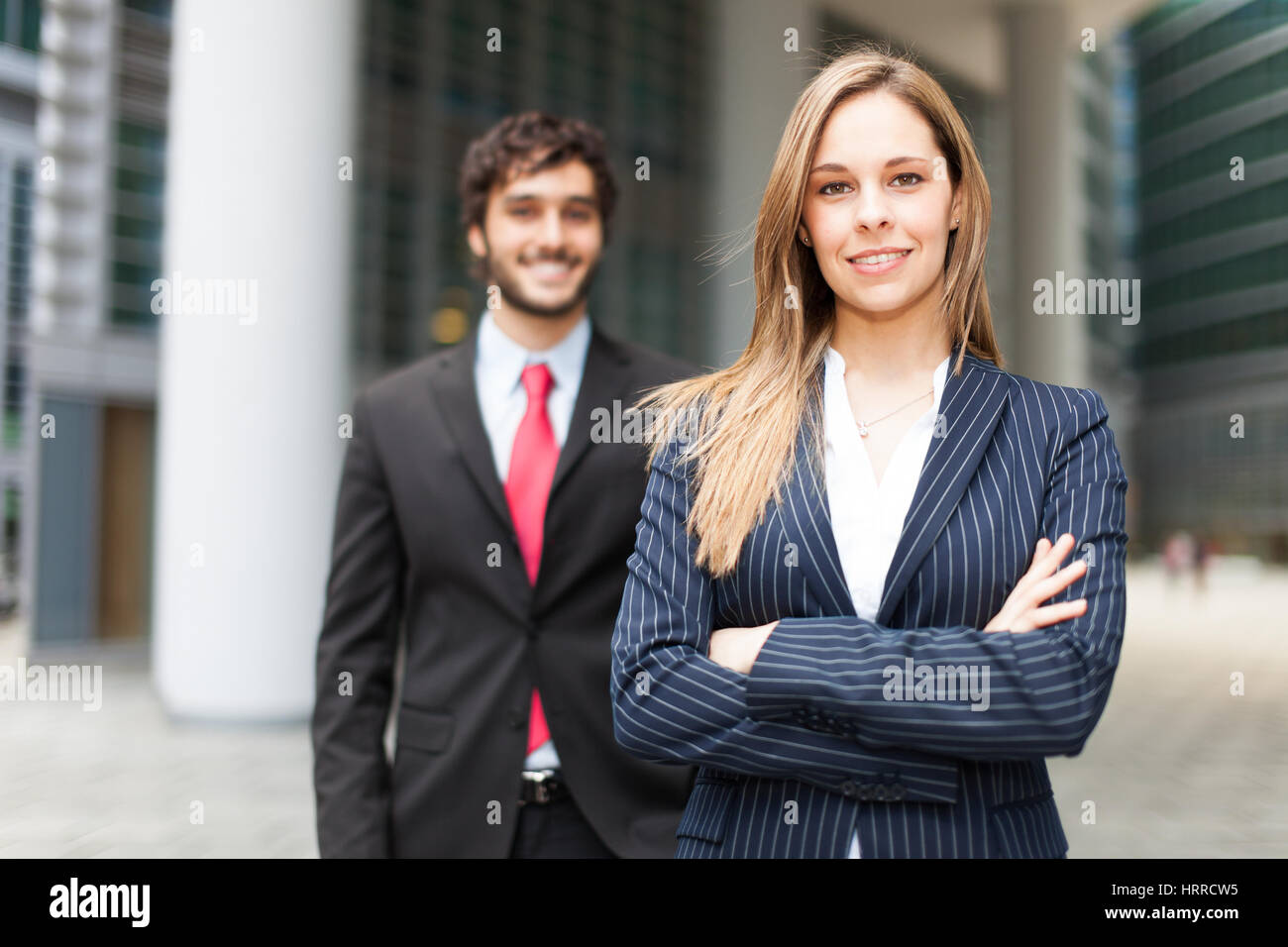 Two smiling business people outdoor Stock Photo - Alamy