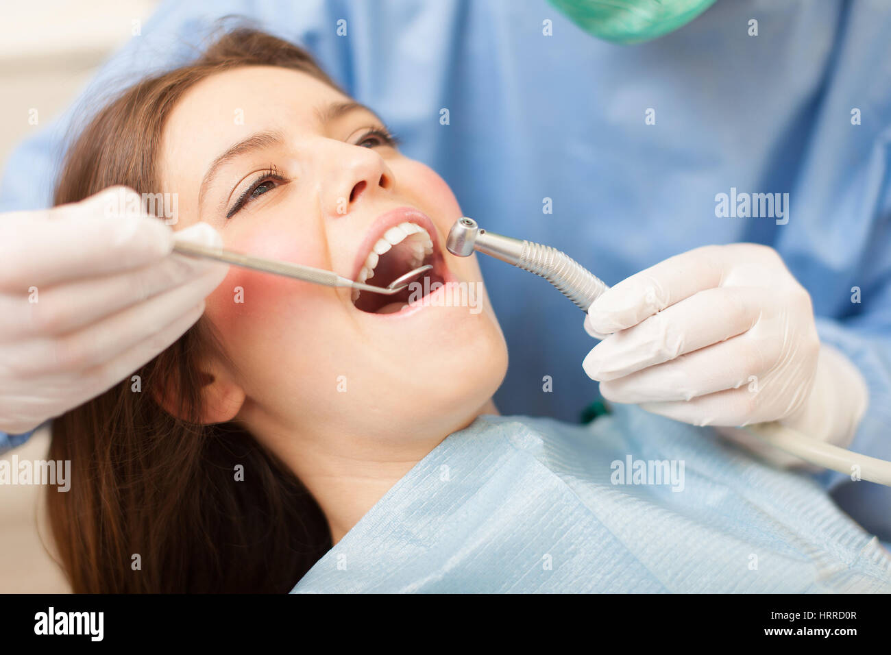 Dentist doing a dental treatment on a patient Stock Photo - Alamy
