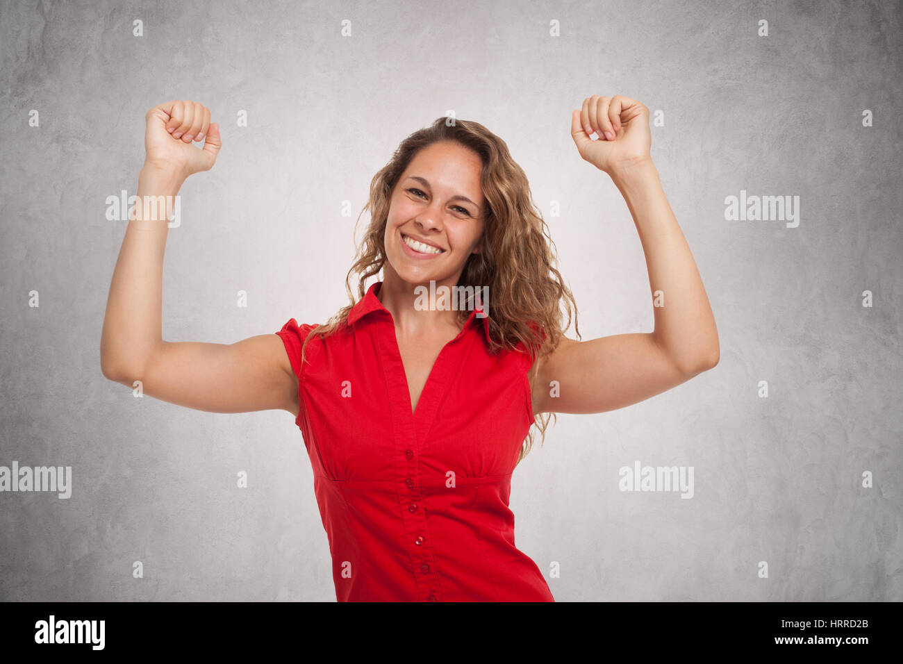 Portrait of an happy woman raising her arms Stock Photo - Alamy