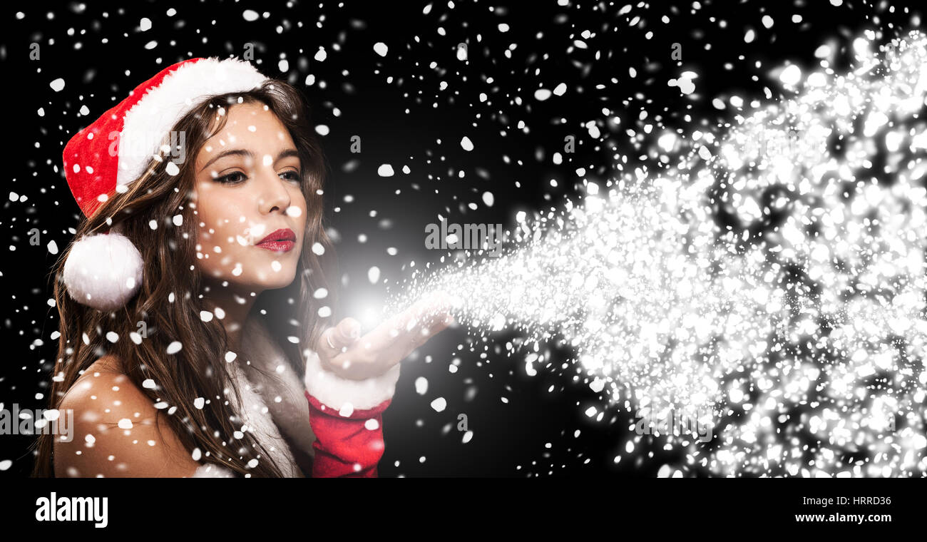 Portrait of a beautiful Christmas girl breathing magic snow Stock Photo ...