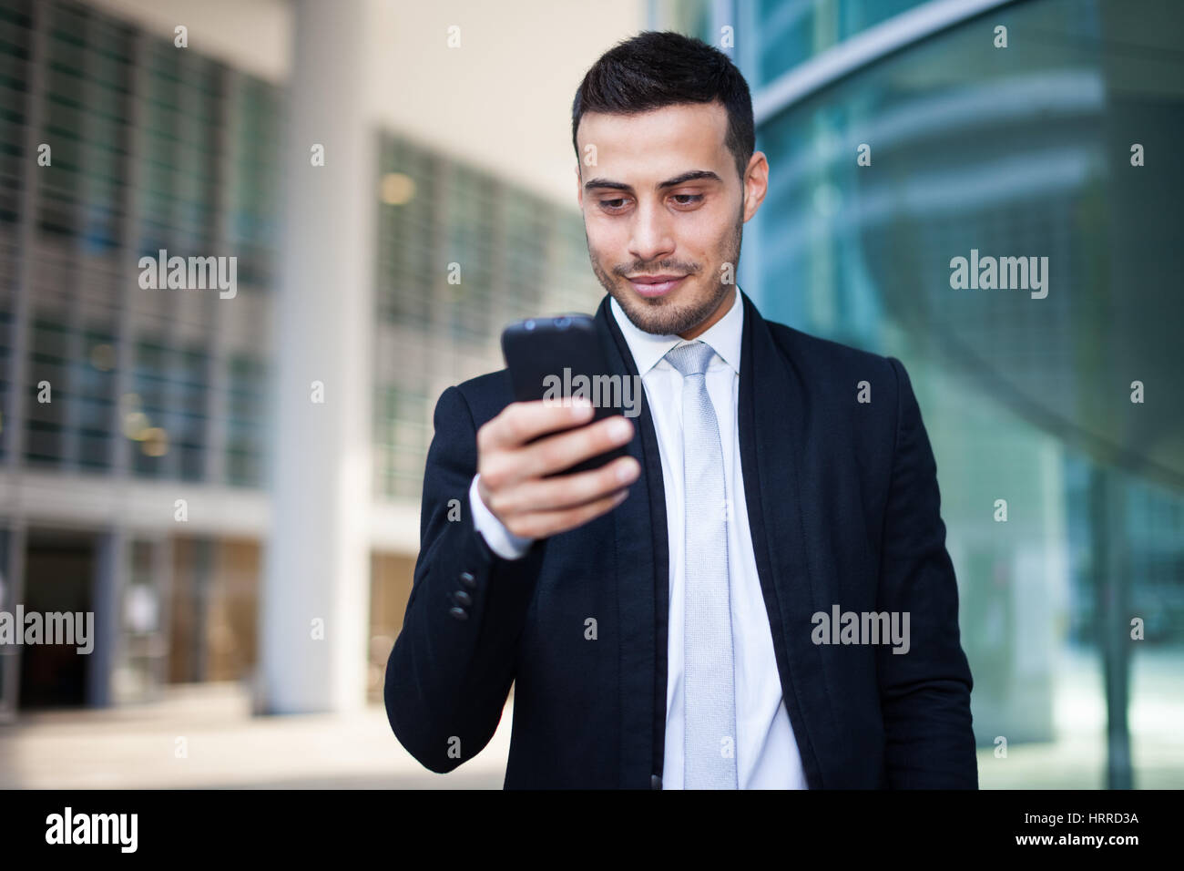 Businessman using his smartphone Stock Photo - Alamy