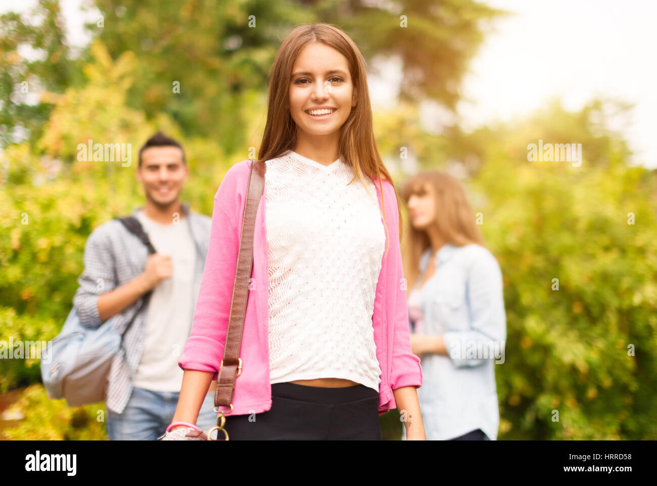 Portrait of a student in a park. Sun flare effect Stock Photo - Alamy