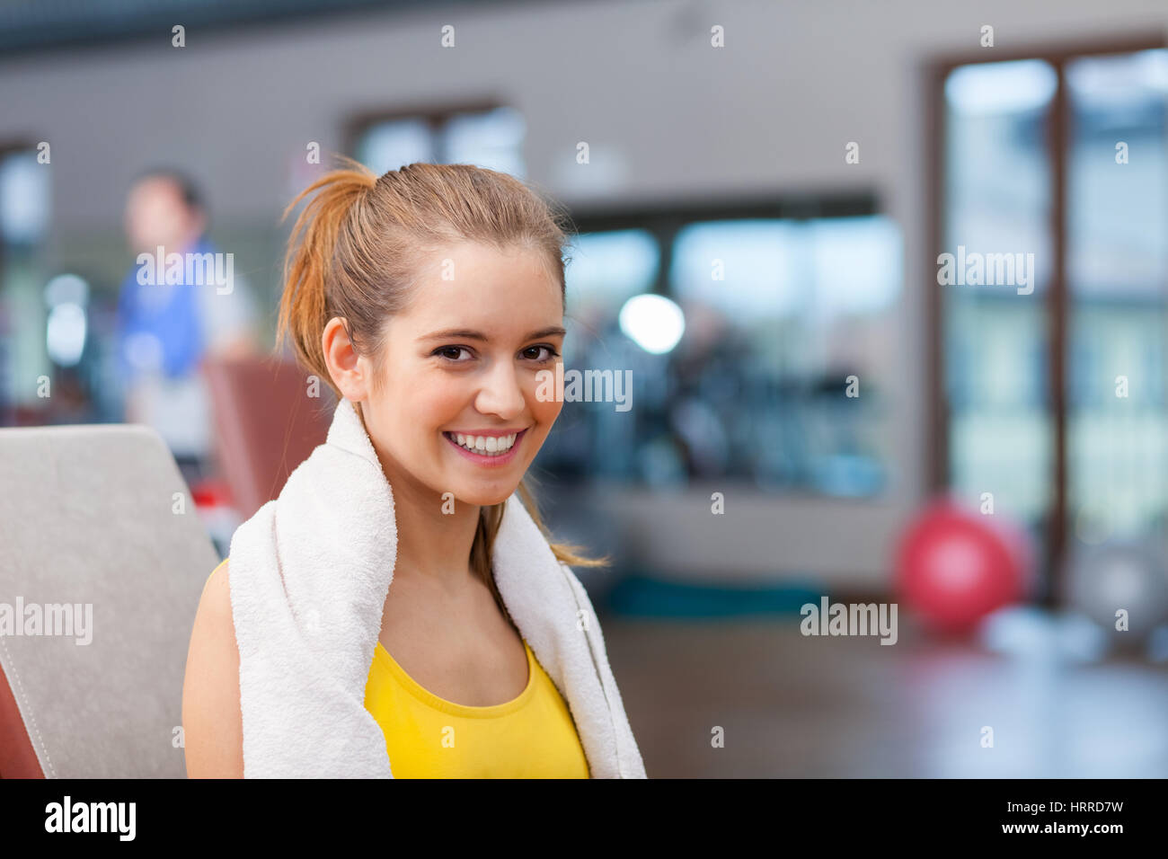 Portrait of a smiling young woman in a gym Stock Photo - Alamy