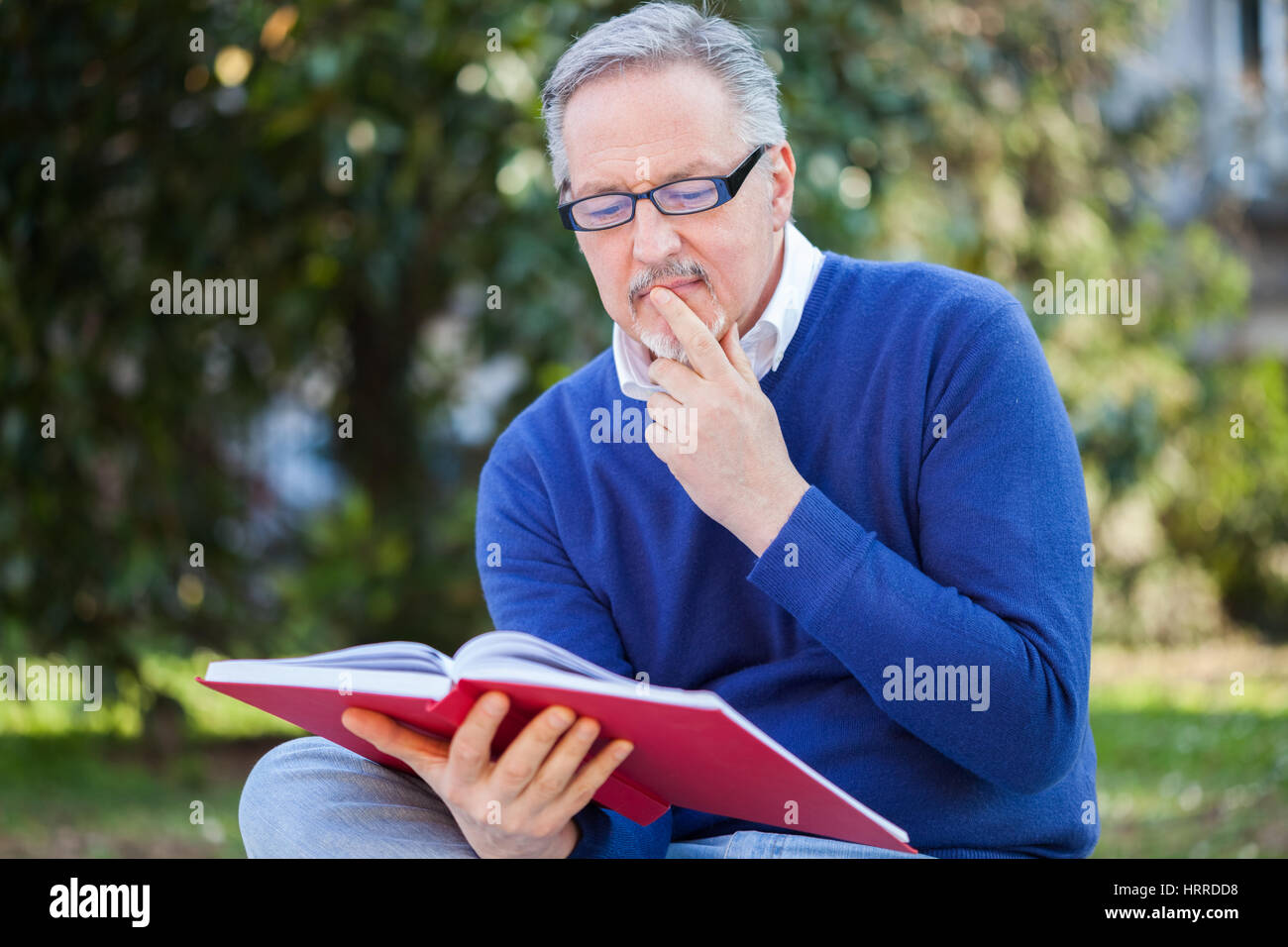 Man reading a book Stock Photo - Alamy