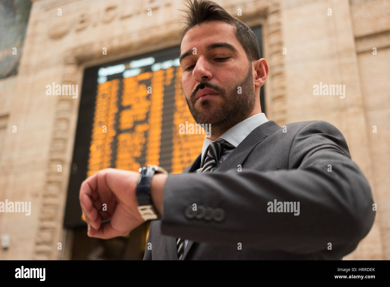 Commuter checking time in front of a timetable Stock Photo - Alamy