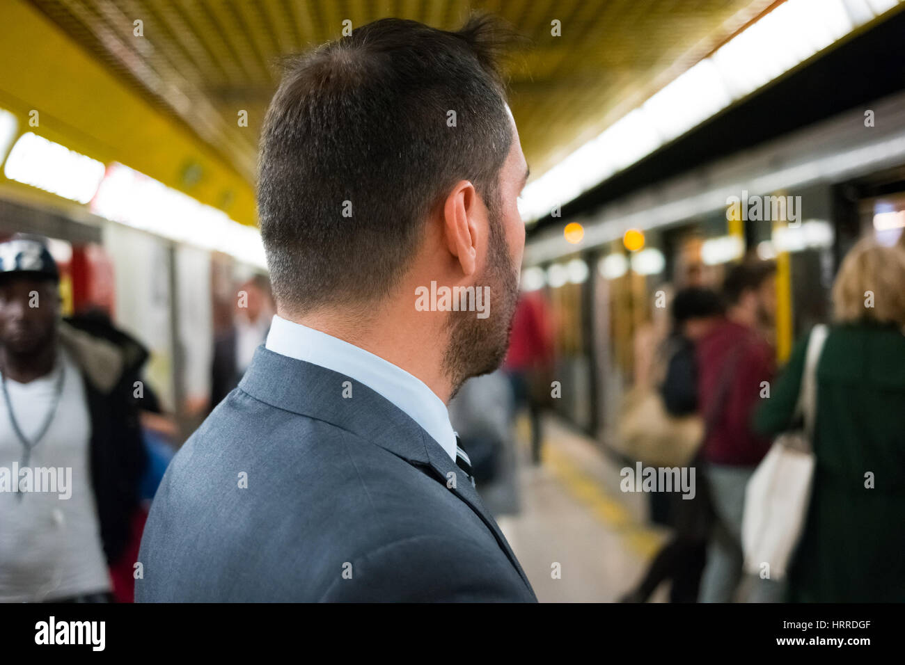 Commuter going on the train in a subway station Stock Photo - Alamy