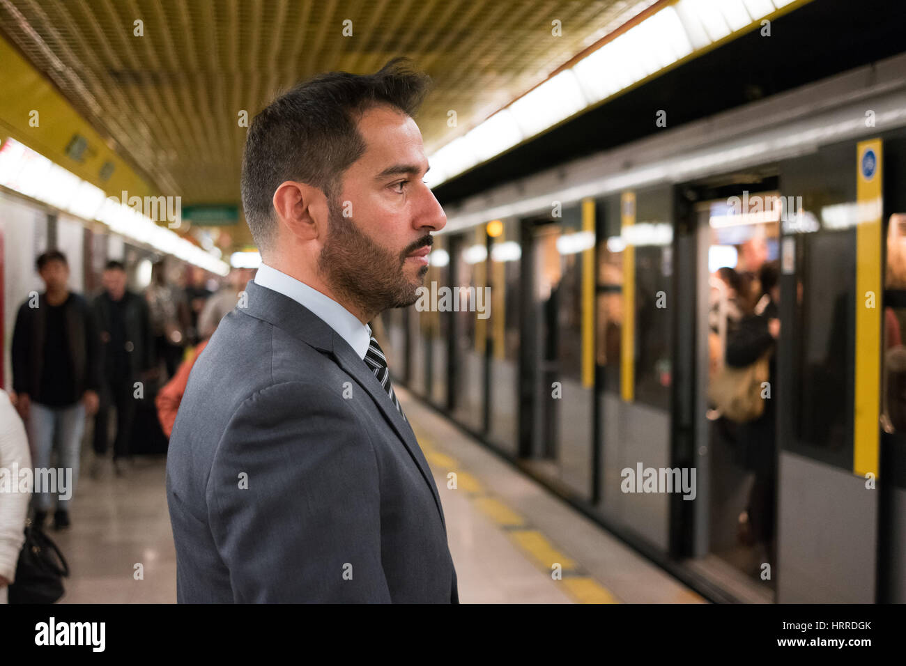 Commuter going on the train in a subway station Stock Photo - Alamy