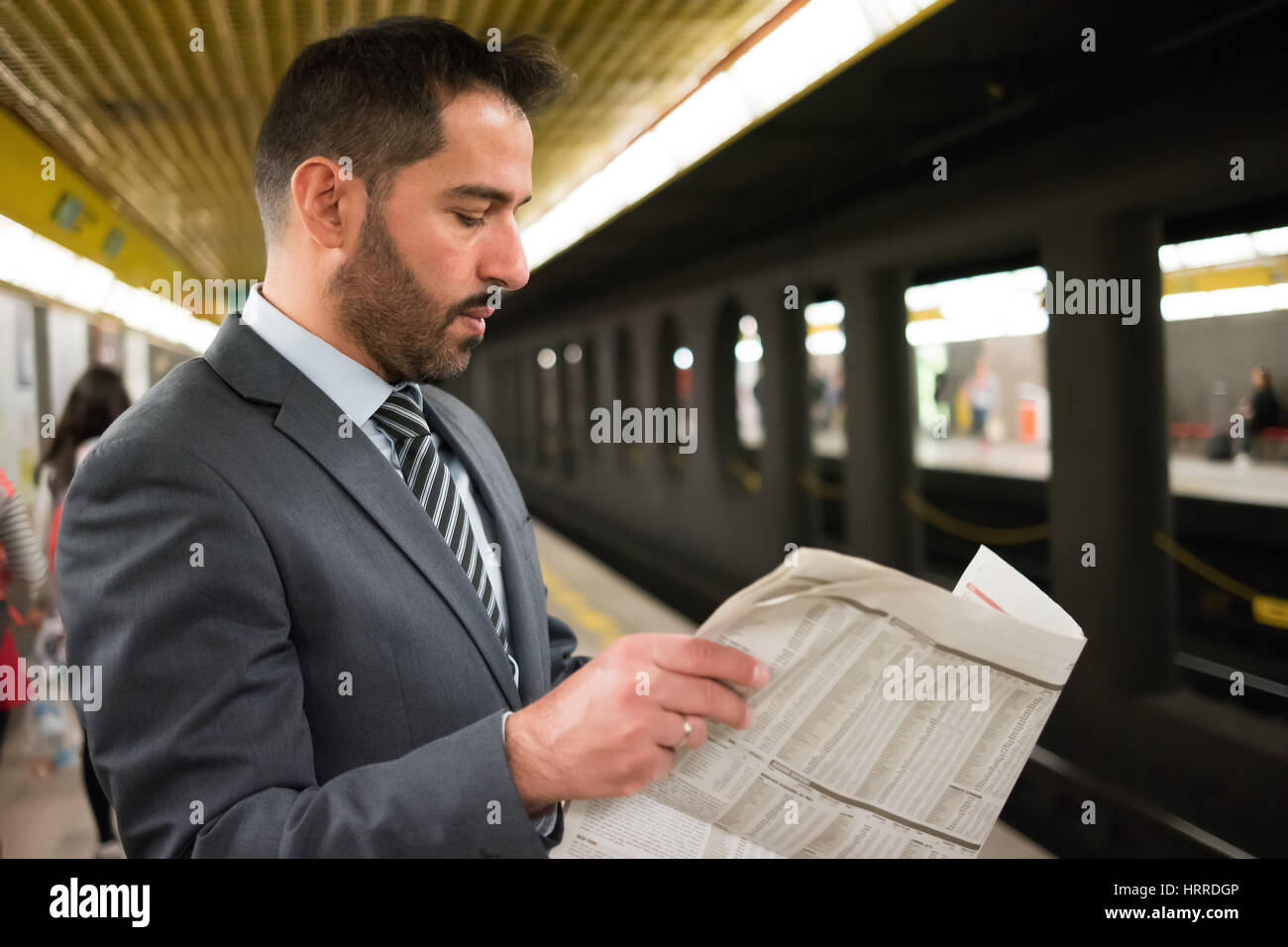 Commuter reading newspaper waiting subway hi-res stock photography and ...