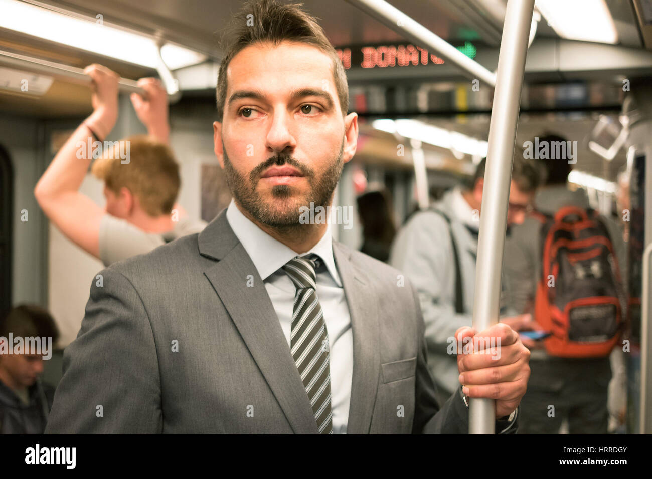 Portrait of a man traveling in a subway train Stock Photo - Alamy