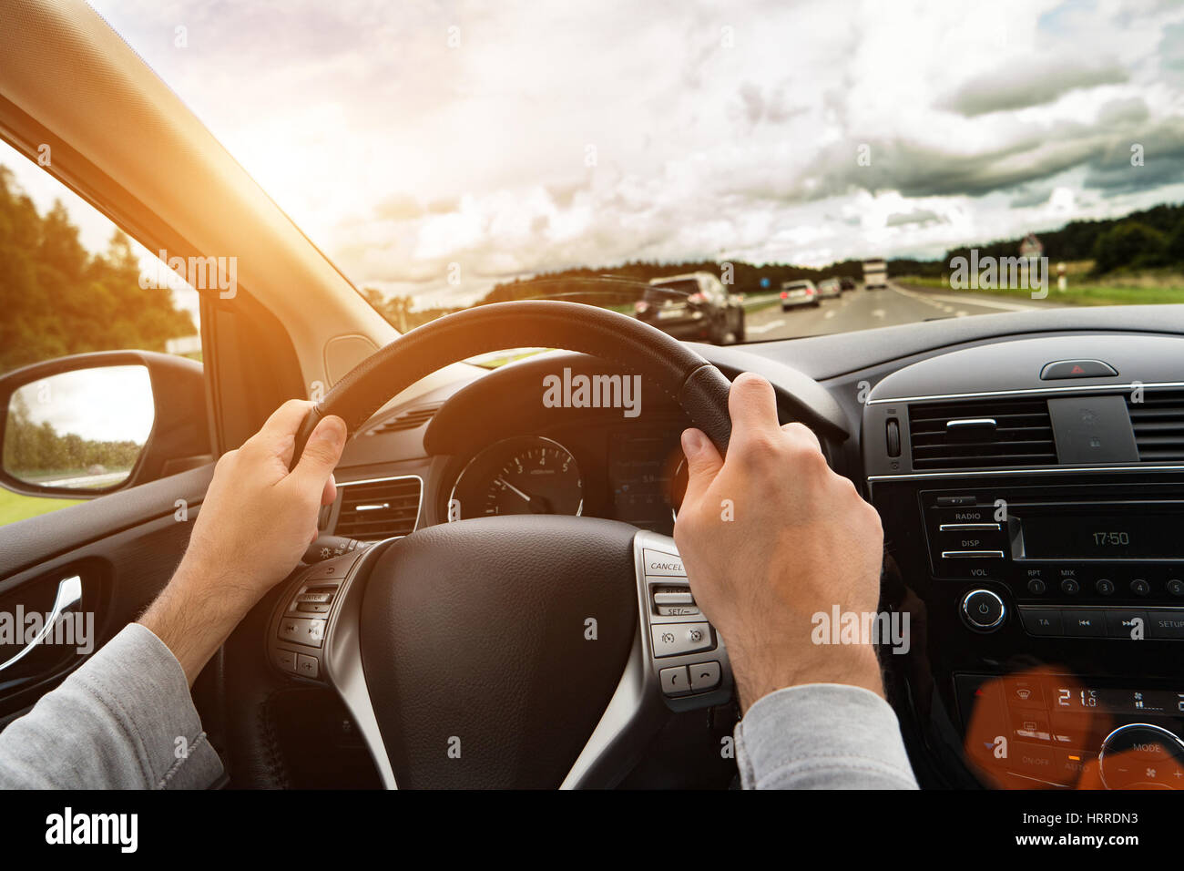 Detail of a man driving his car. Bright light effect Stock Photo - Alamy
