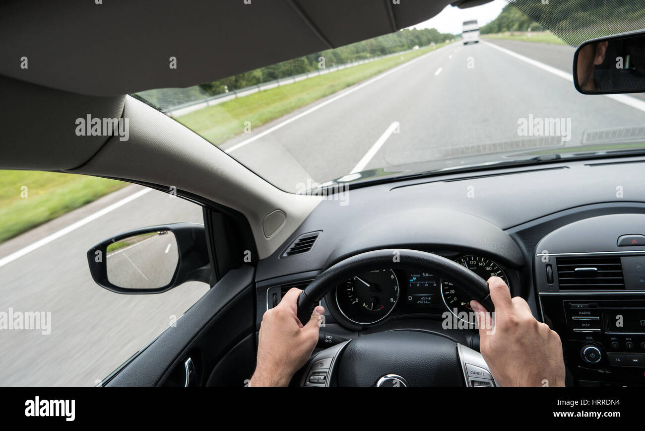 Man driving his car. Focus on the hands Stock Photo - Alamy