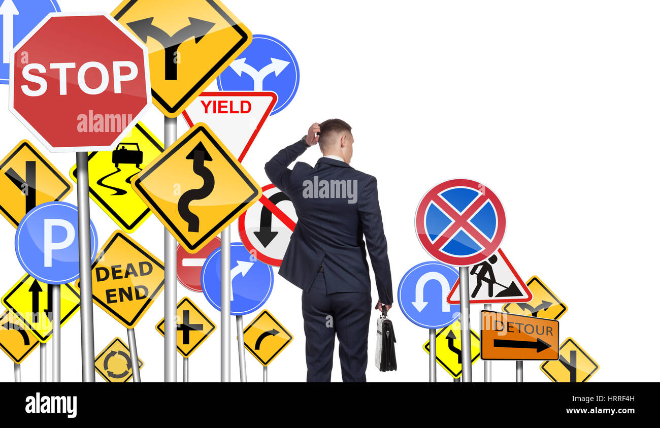 Businessman is confused due to a lot of road signs, tries choosing the ...