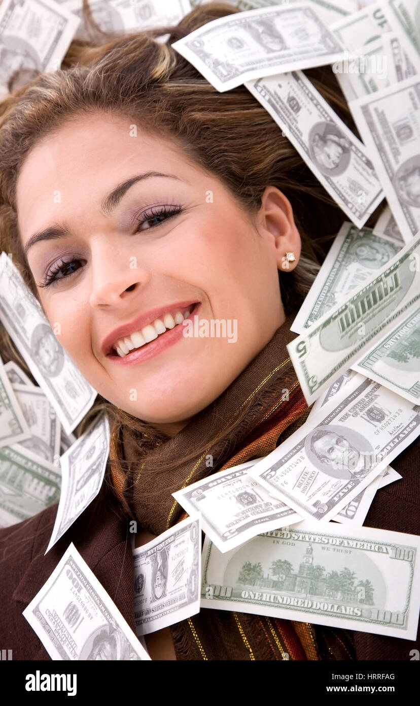 business woman millionaire with money around her face Stock Photo - Alamy