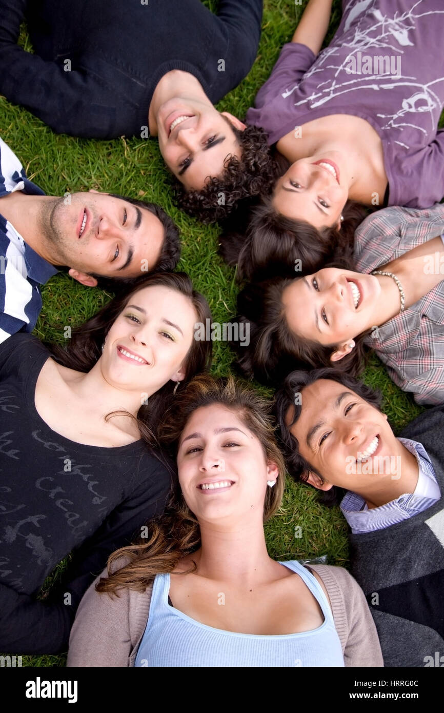 happy group of friends together on the floor outdoors Stock Photo - Alamy