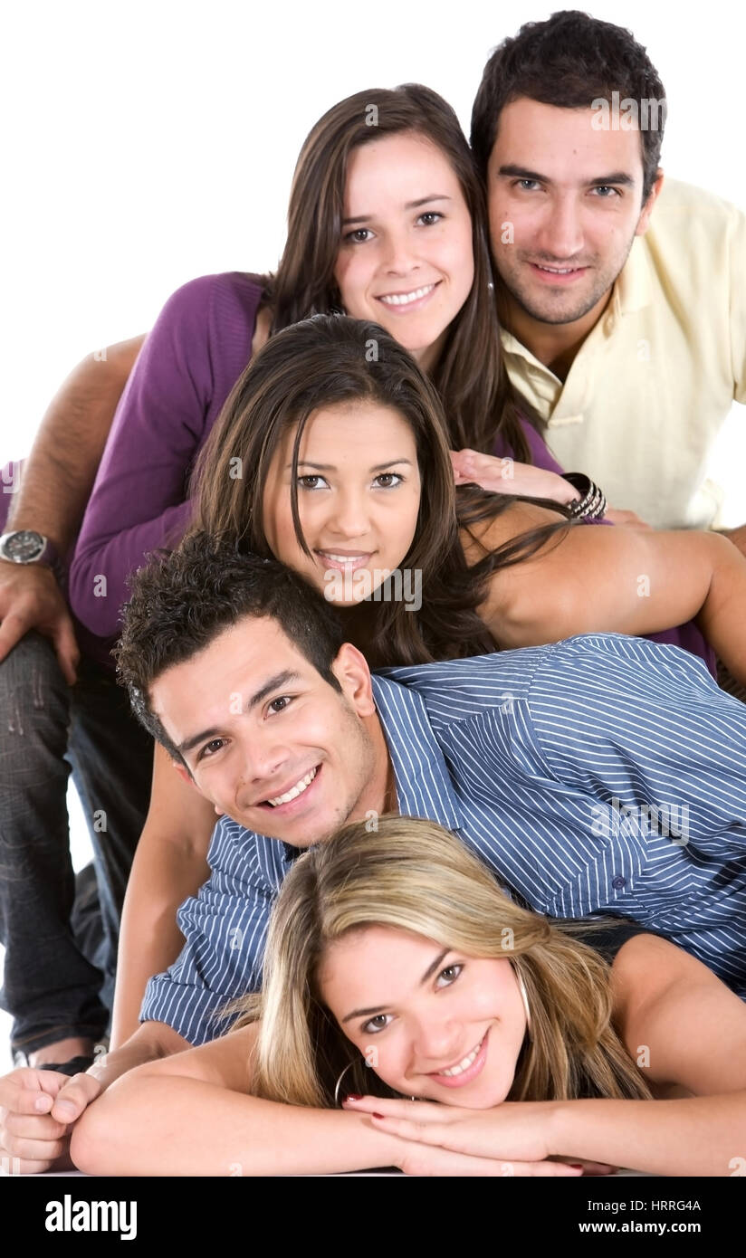 Happy group of friends with their heads together on the floor isolated ...
