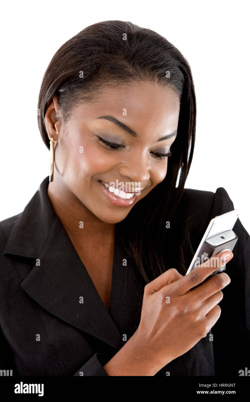 Business woman sending a text message on her mobile phone - isolated ...