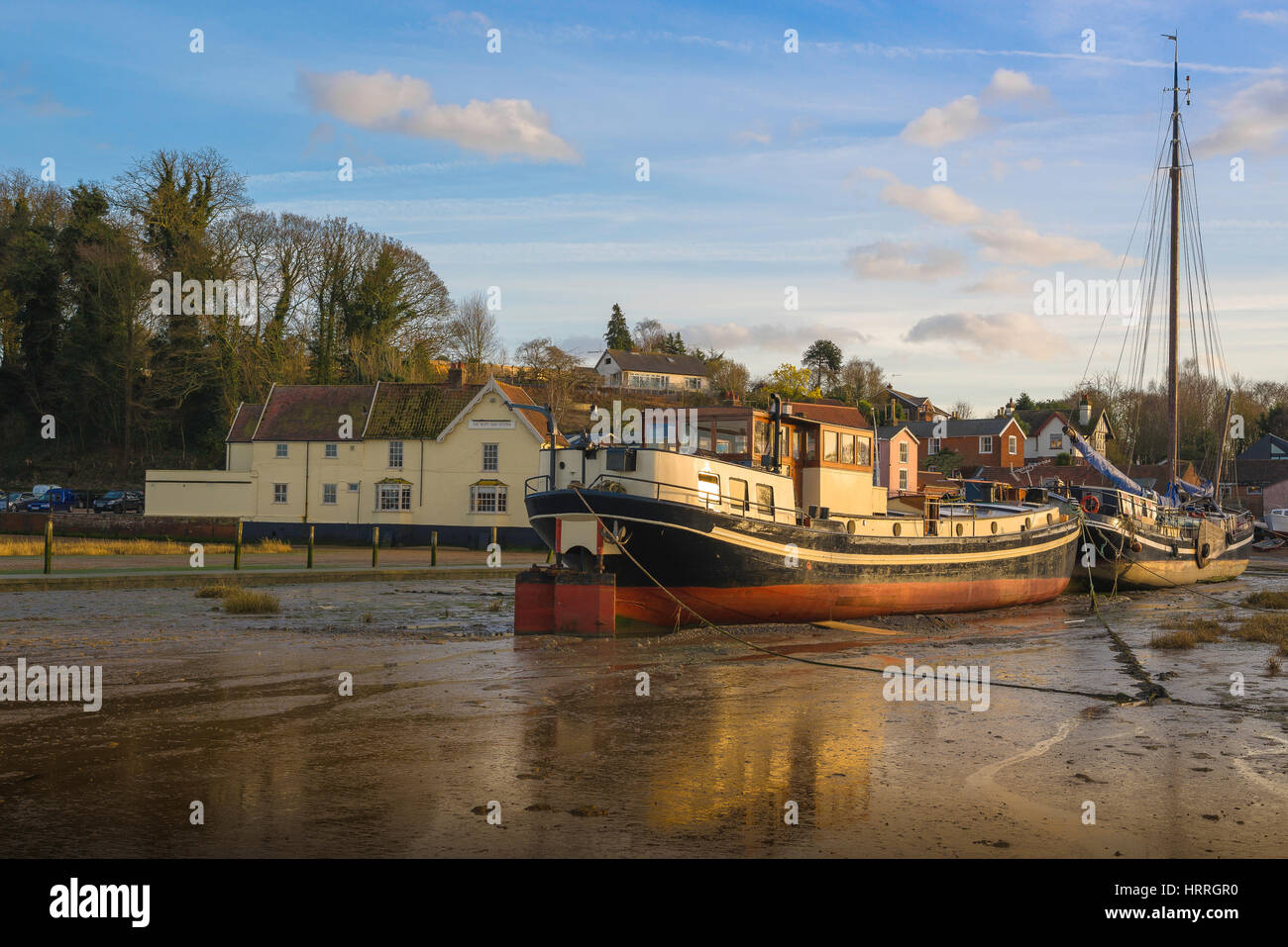 Suffolk landscape, old river boats sit in the River Orwell at low tide ...