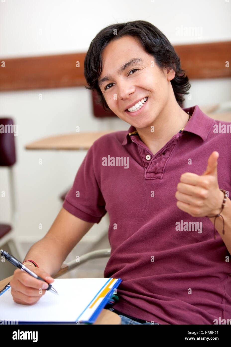 College student in a classroom with thumbs up Stock Photo - Alamy