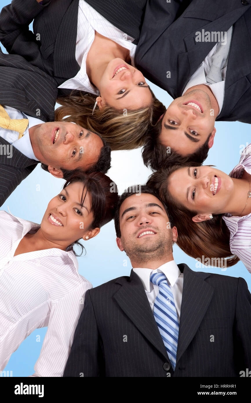 business team with heads together on the floor isolated Stock Photo - Alamy