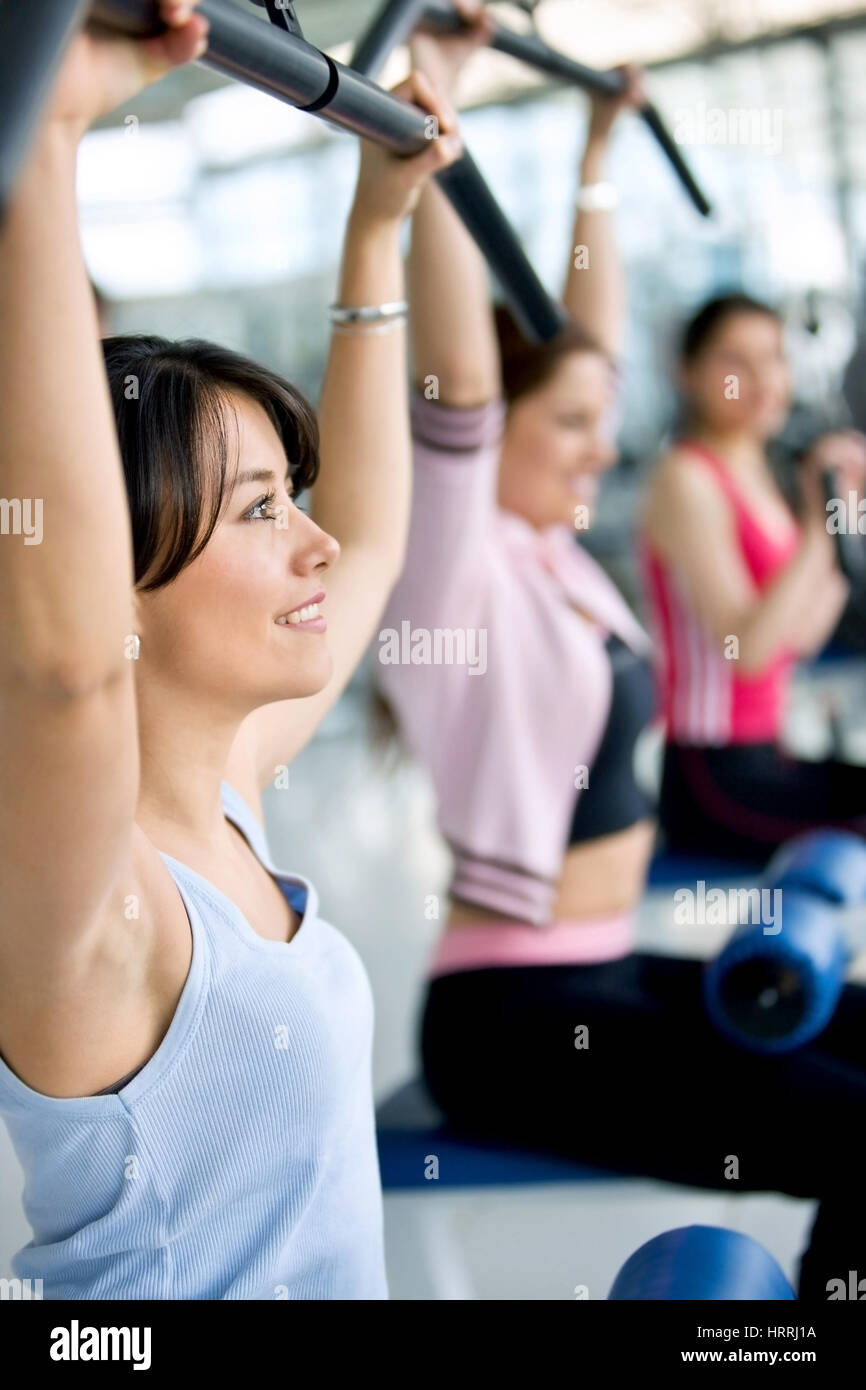 woman at the gym exercising on a machine Stock Photo - Alamy