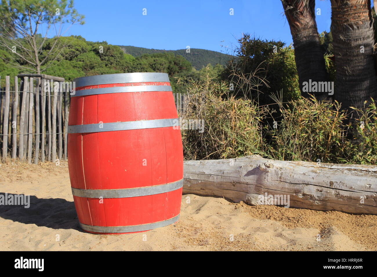 Bright red wooden barrel on a beach in tropical beach paradise with ...
