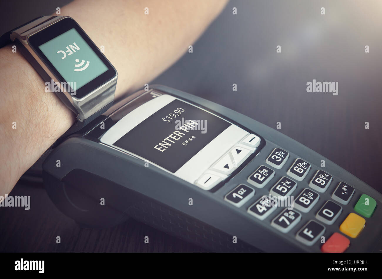 Man making payment through smartwatch via NFC contactless technology ...