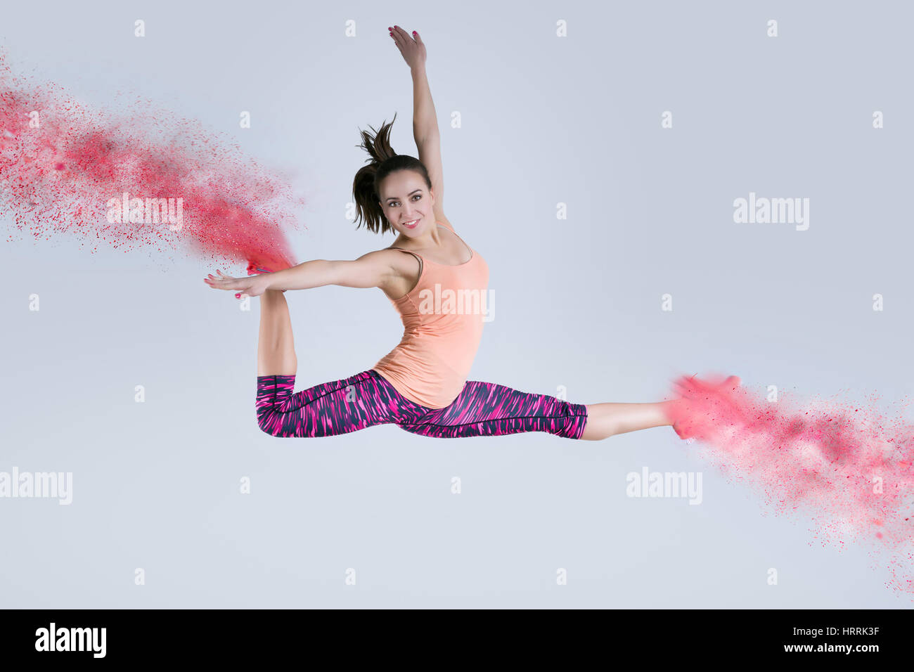 Woman in jump. Frozen motion. Photo manipulation of disintegration ...