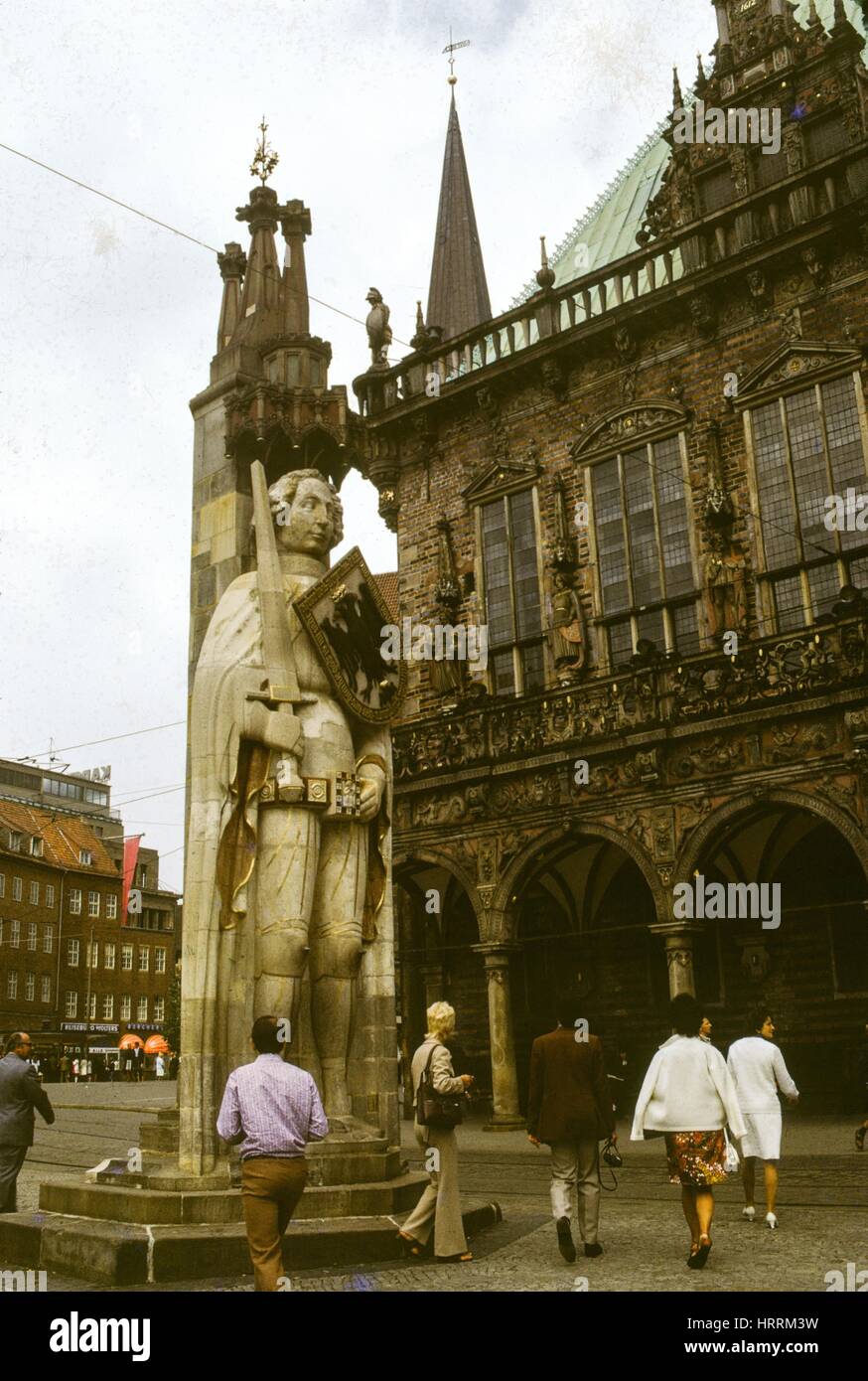 Tourists walk past the Bremen Roland, a Roland statue depicting a ...