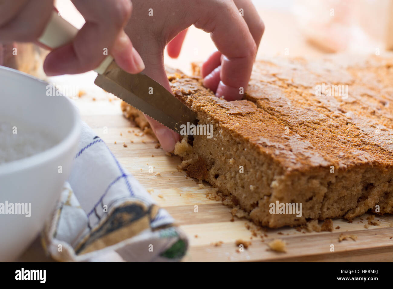 Female hands cutting and preparing cake crust on wooden plate Stock ...