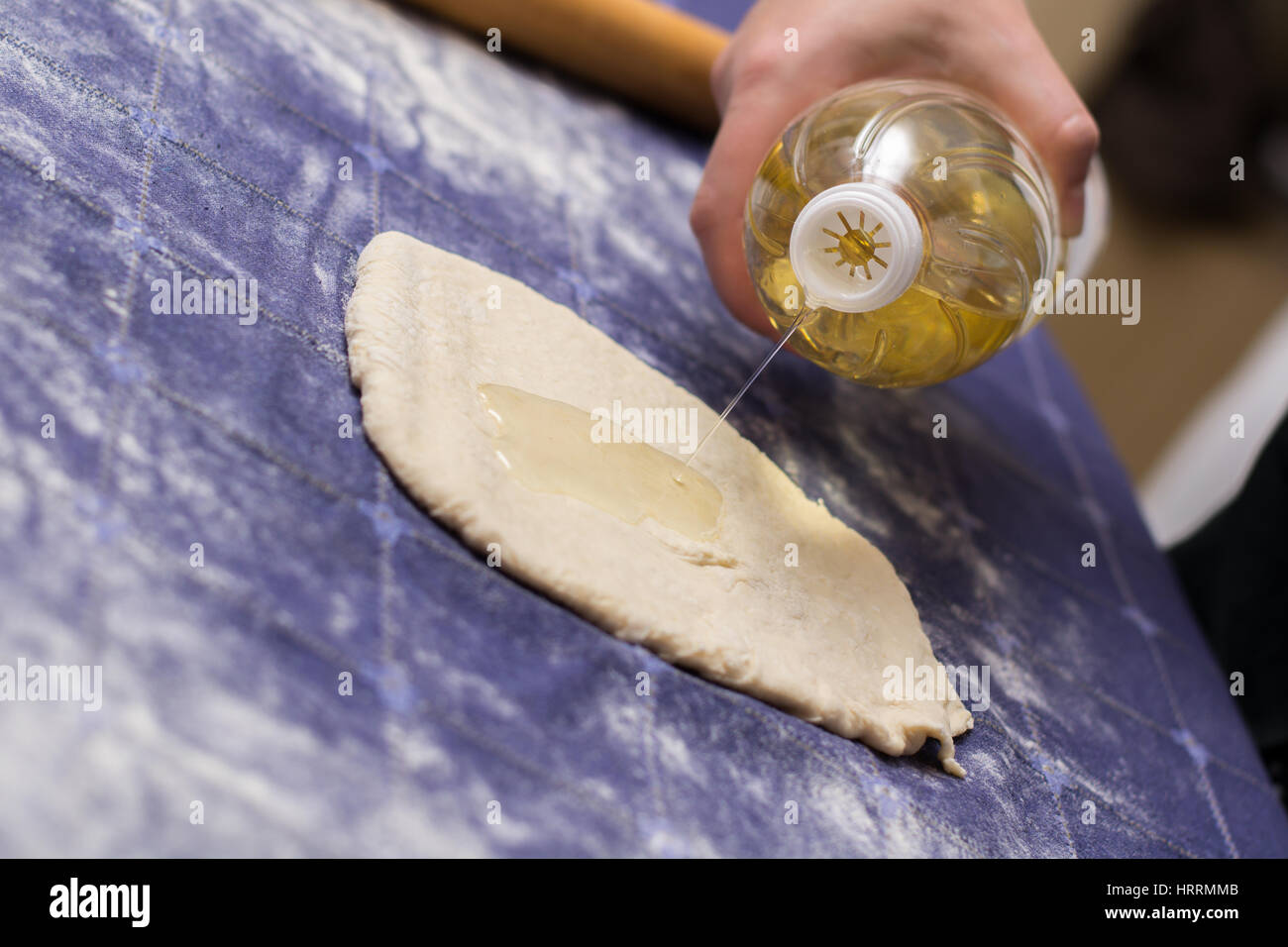 Creating homemade Phyllo or strudel dough on a home table cloth for ...