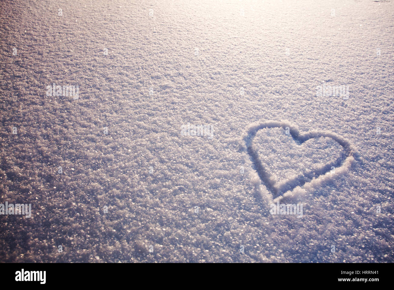 Beautiful romantic background with heart on snow. Snow patterns ...
