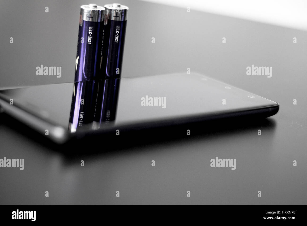A modern smart phone and batery Stock Photo - Alamy