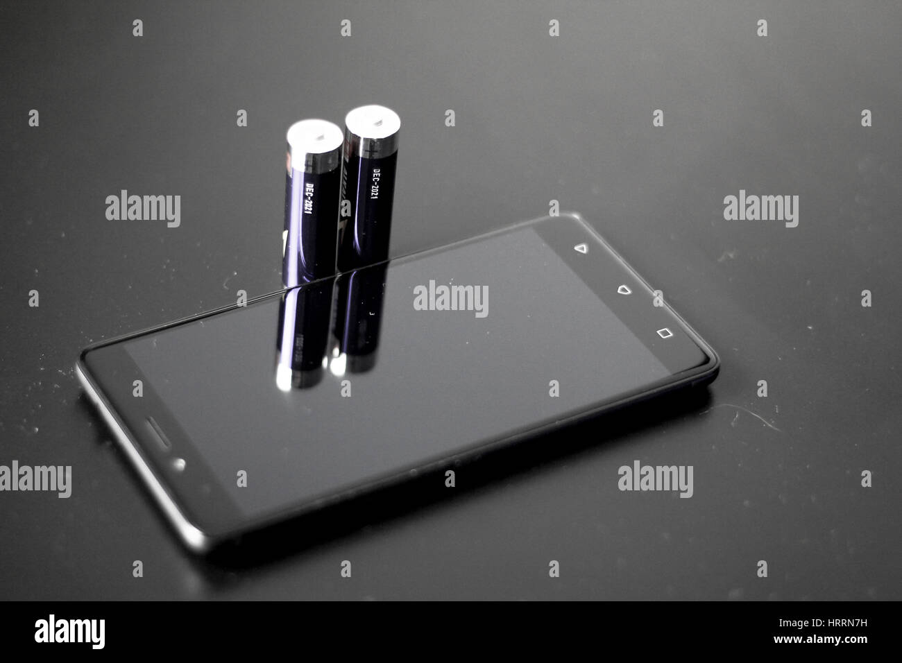 A modern smart phone and batery Stock Photo - Alamy