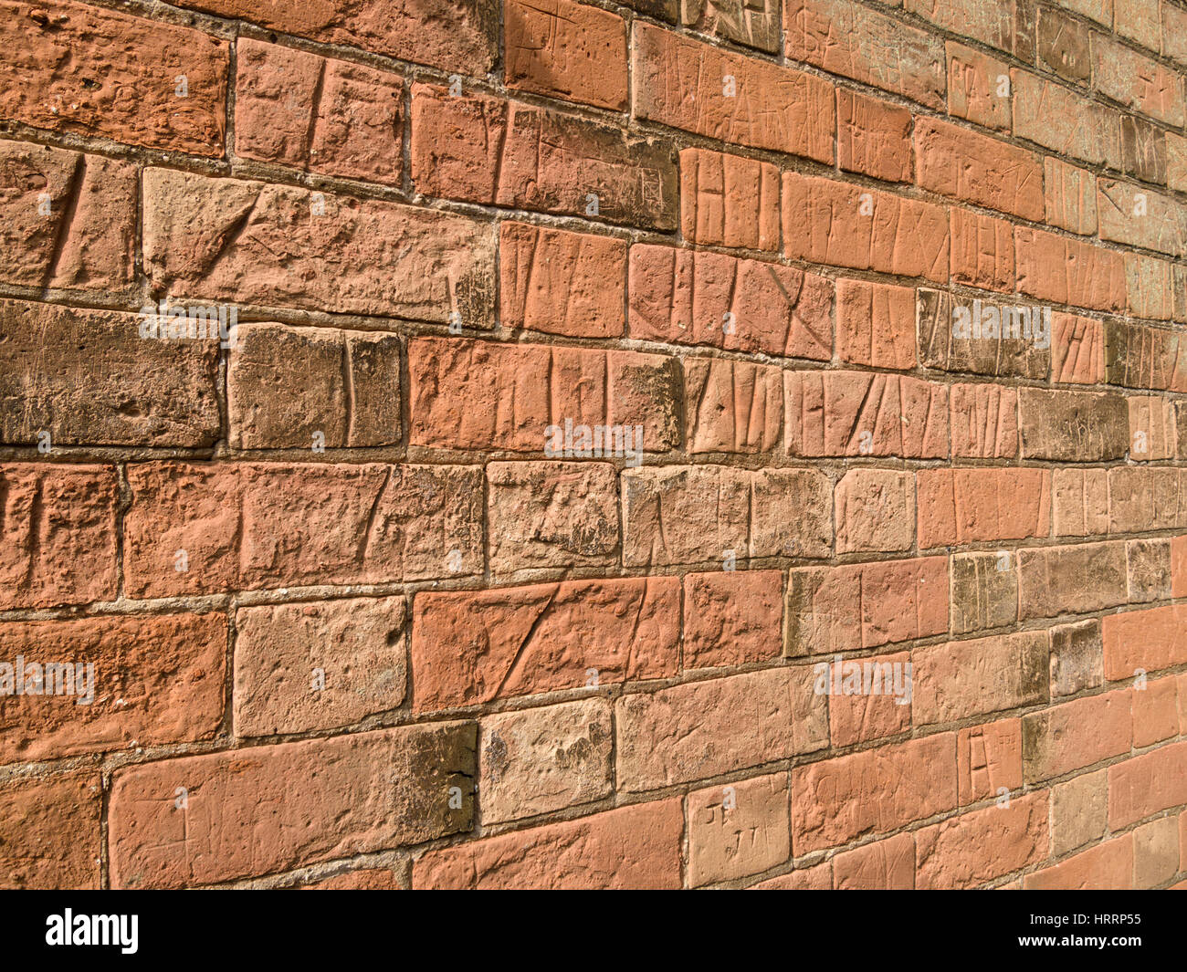 Names and graffiti scratched into old red brick school wall, Frisby on ...