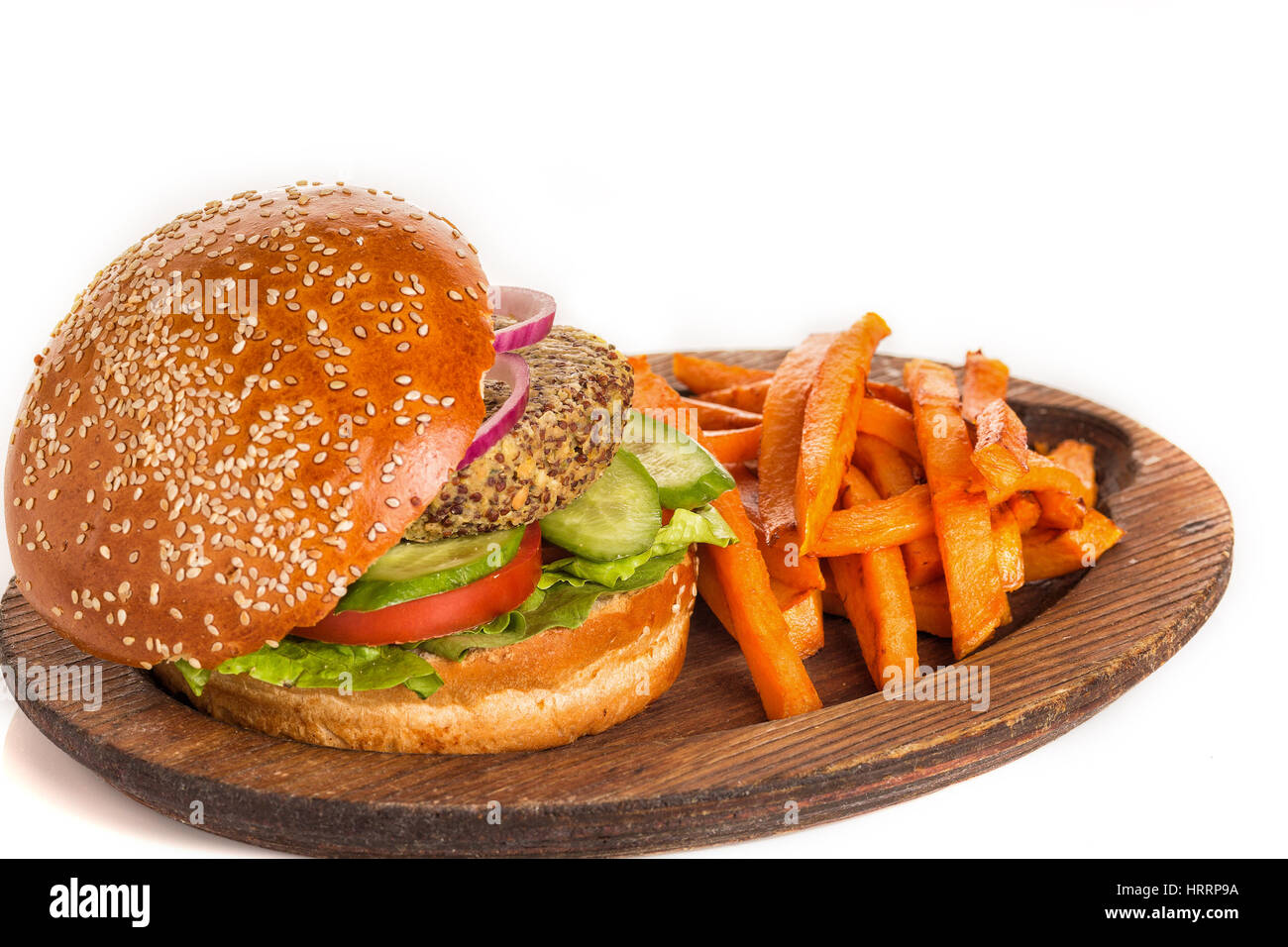 Vegetarian burger with vegetables in a wooden plate on a white ...