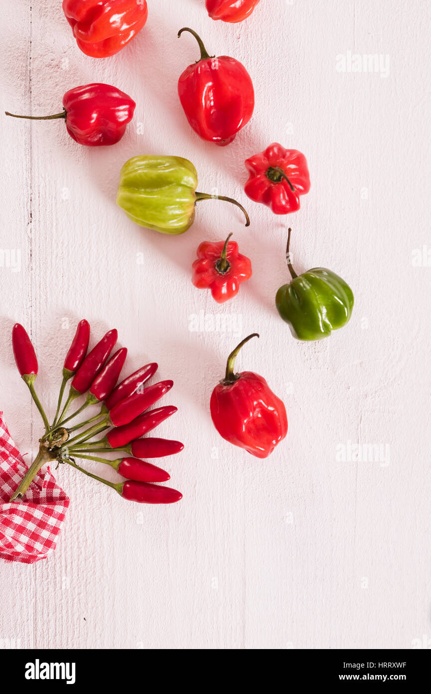 Red hot chili peppers on wooden table Stock Photo - Alamy