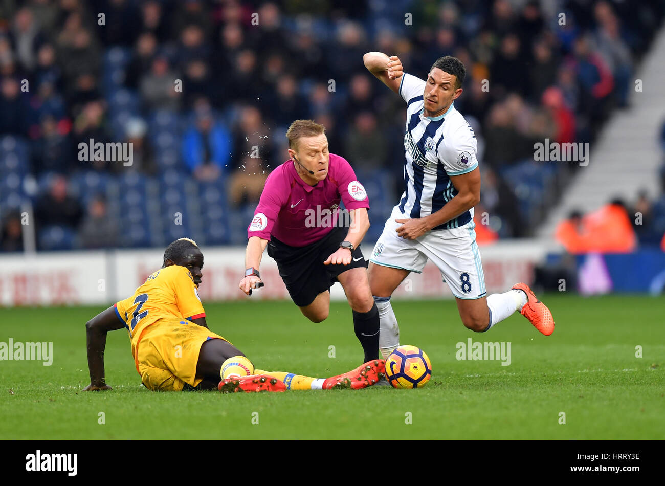 Referee Mike Jones is sent flying having been caught between West ...