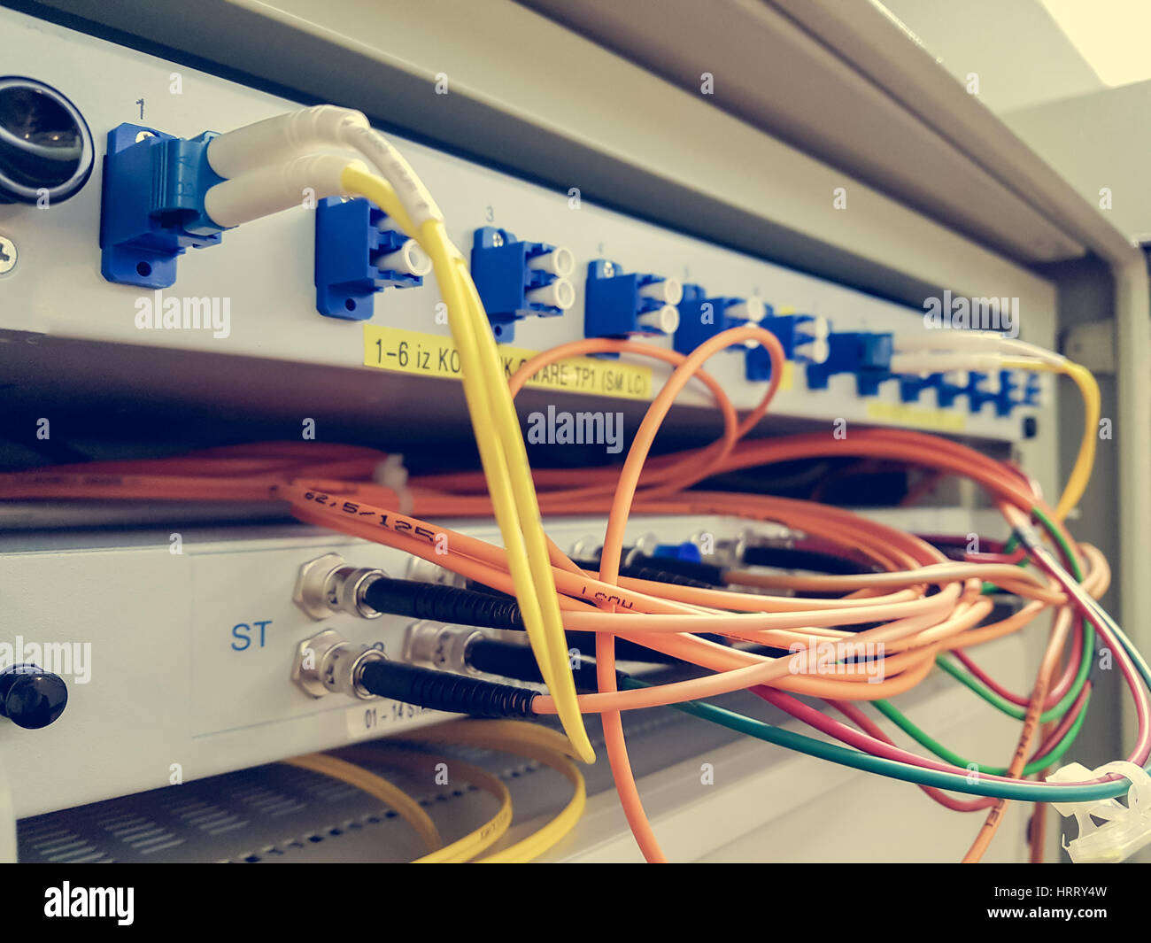 Closeup of fiber optic cable plugged into switch. Internet of things ...