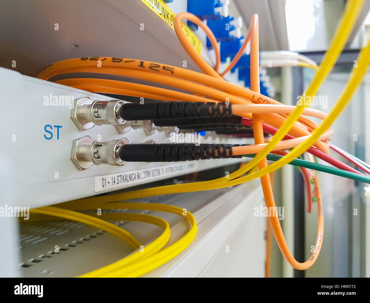 Closeup of fiber optic cable plugged into switch. Internet of things ...