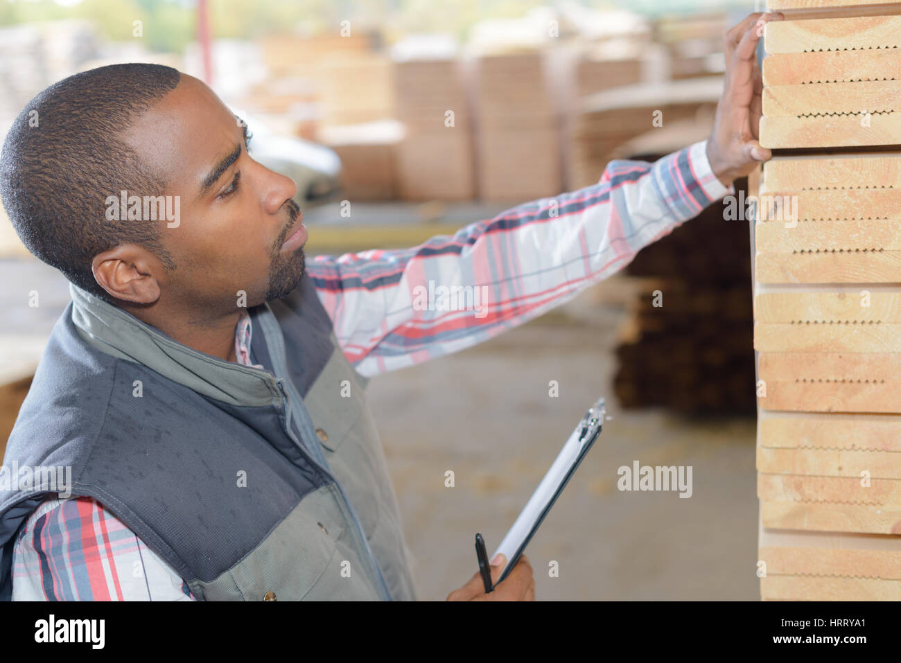Man with clipboard counting stock Stock Photo - Alamy