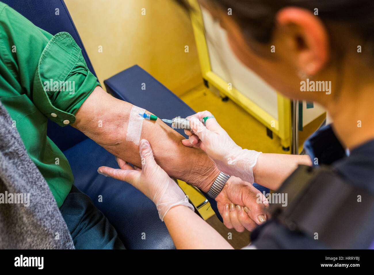 Injection of a radioactive tracer into a patient's vein prior to taking ...