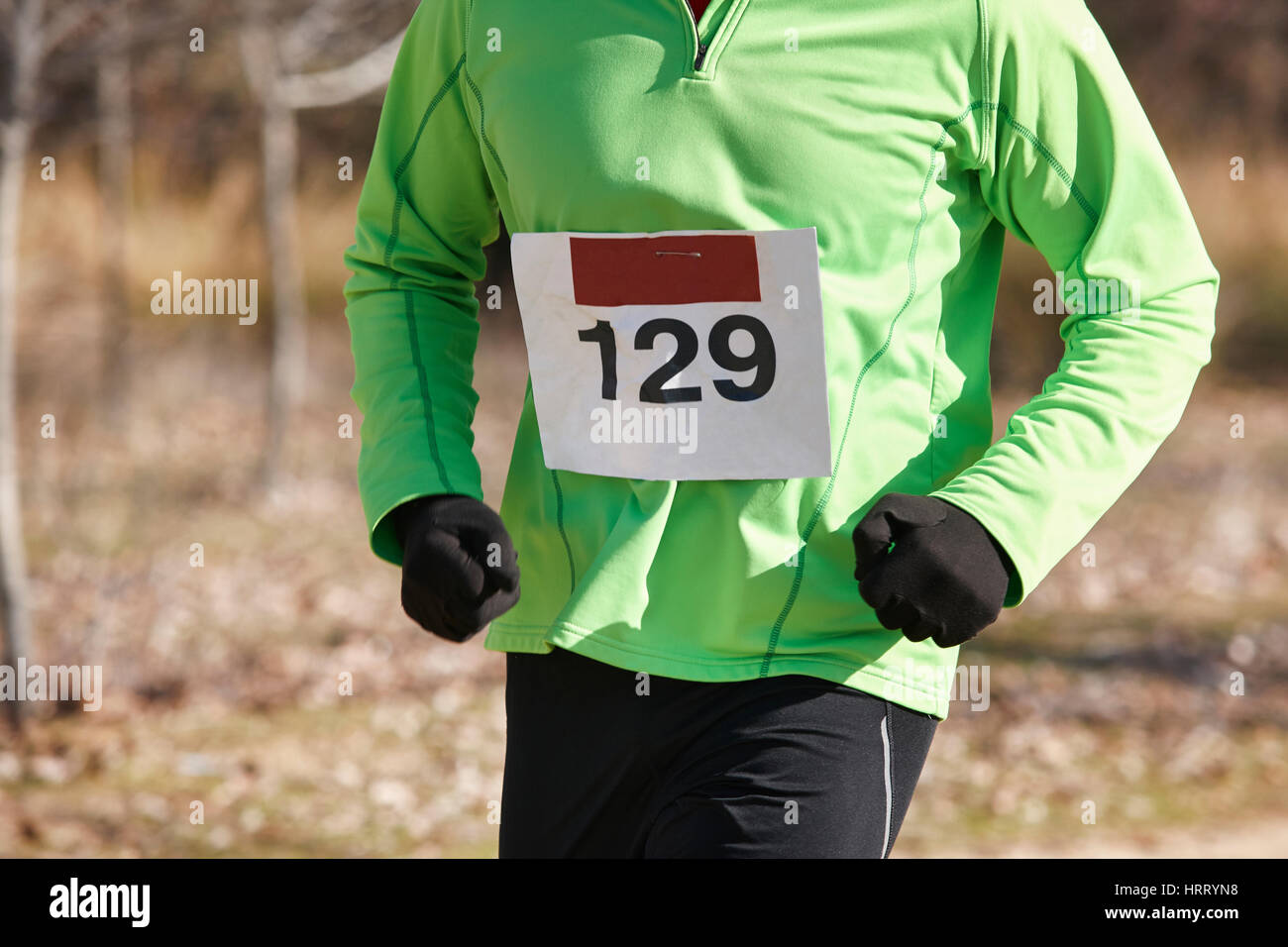 Male athletic runner on a cross country race. Outdoor circuit ...