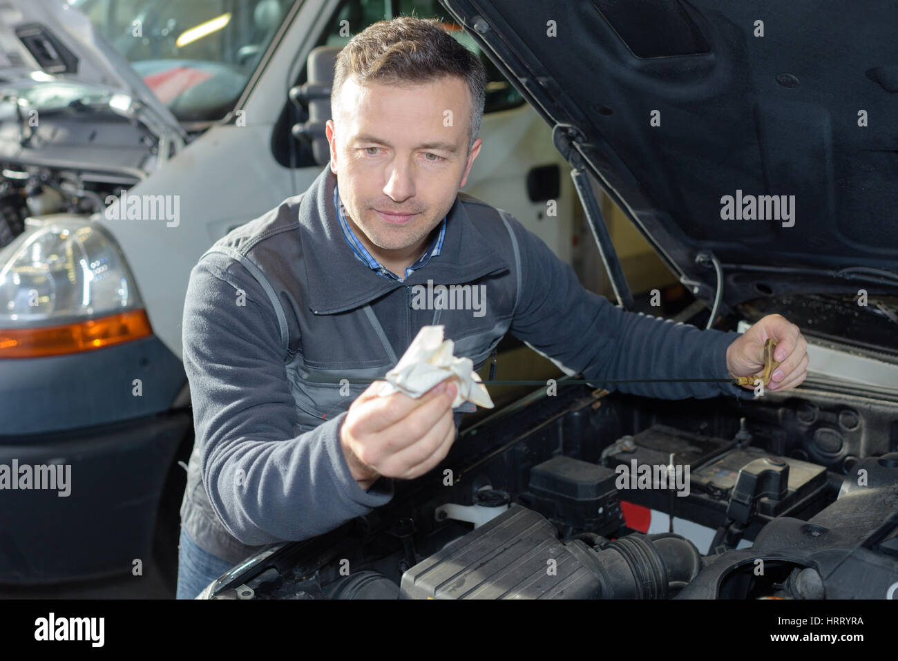 mechanic repairing car in garage Stock Photo - Alamy