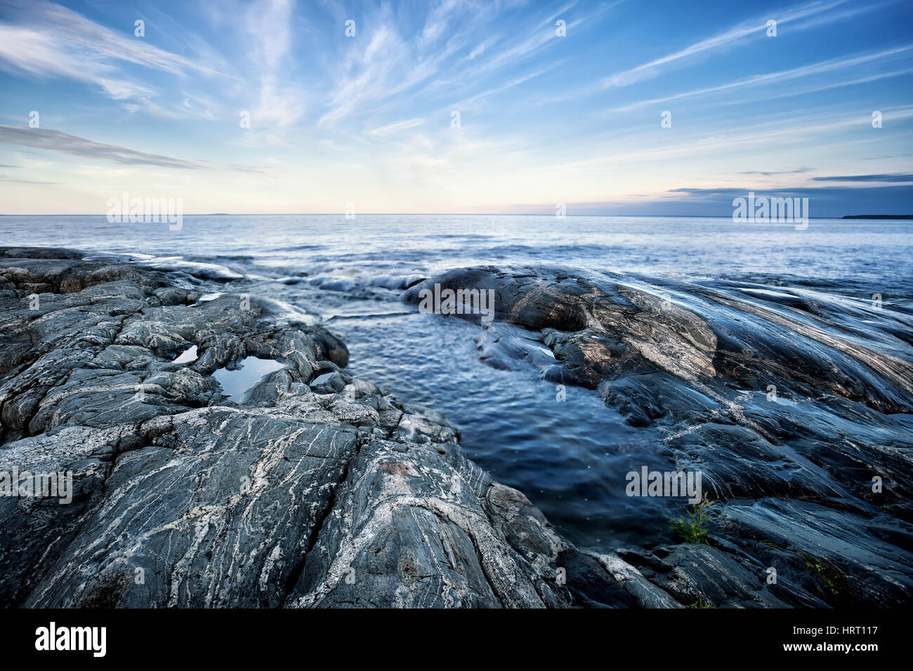Stone coast of the northern island at sunset Stock Photo - Alamy