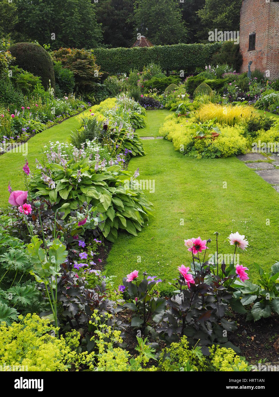Portrait view of Chenies Manor sunken garden, Buckinghamshire. Lush ...