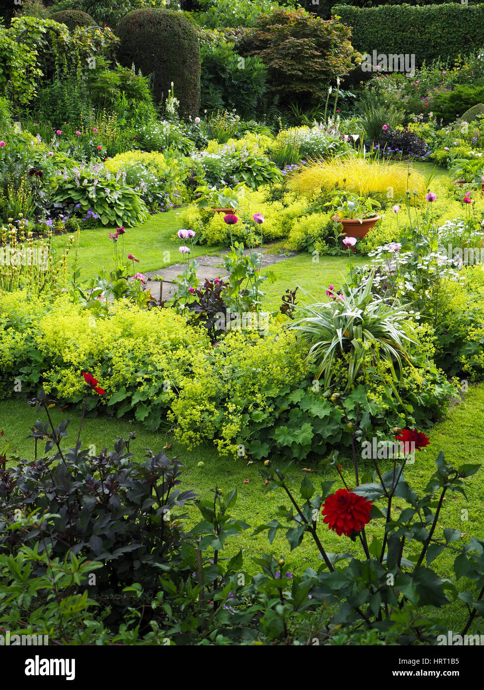Portrait view of Chenies Manor sunken garden, Buckinghamshire. Lush ...