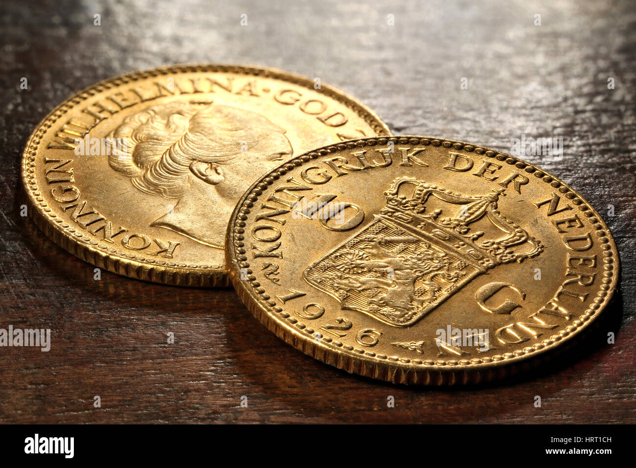 Dutch Wilhelmina gold coins on rustic wooden background Stock Photo - Alamy