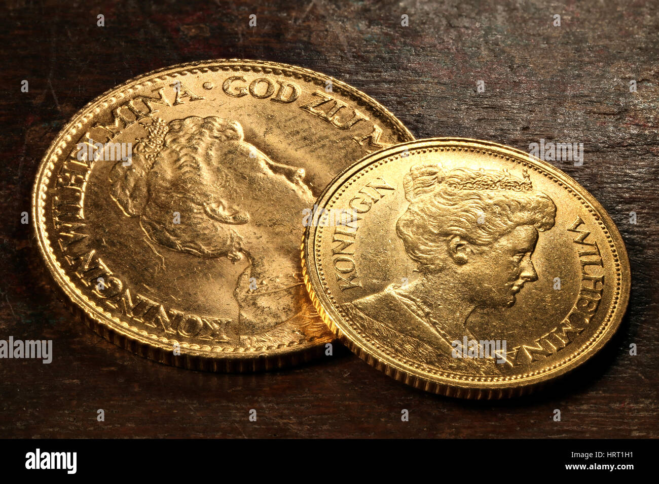 Dutch Wilhelmina gold coins on rustic wooden background Stock Photo - Alamy