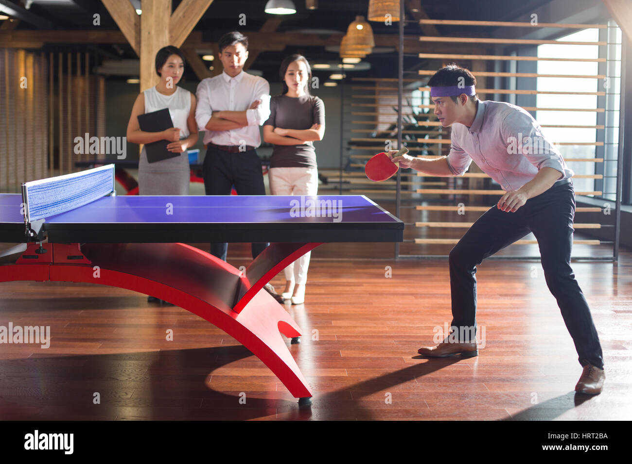 Young businessman playing ping pong Stock Photo - Alamy