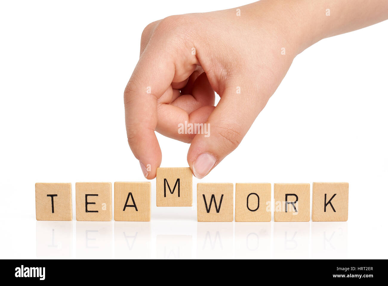 Hand is building the word teamwork on white background Stock Photo - Alamy